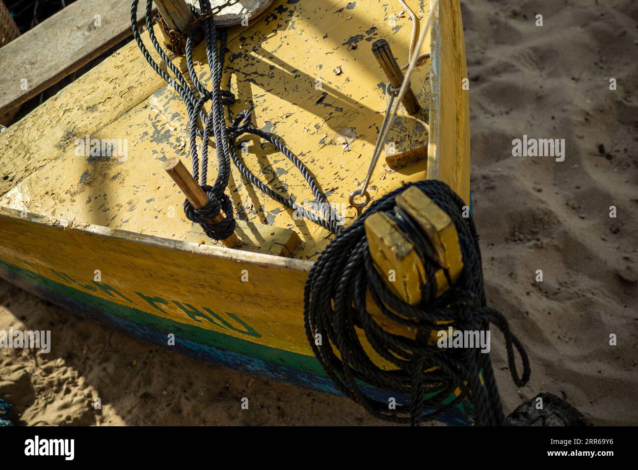 Front detail of a yellow boat docked on the beach sand. Sea transport ...