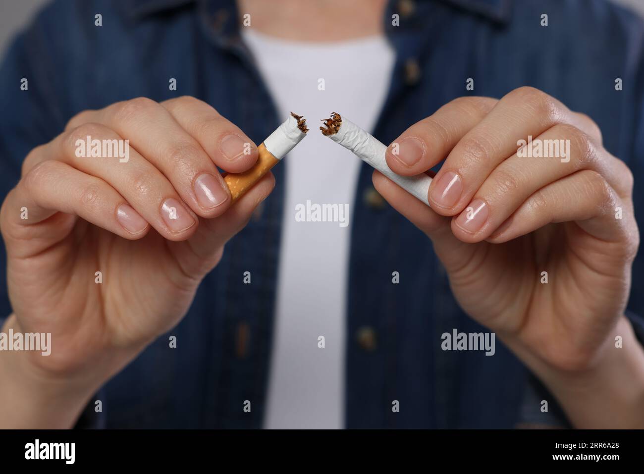 Stop smoking concept. Woman holding pieces of broken cigarette, closeup ...