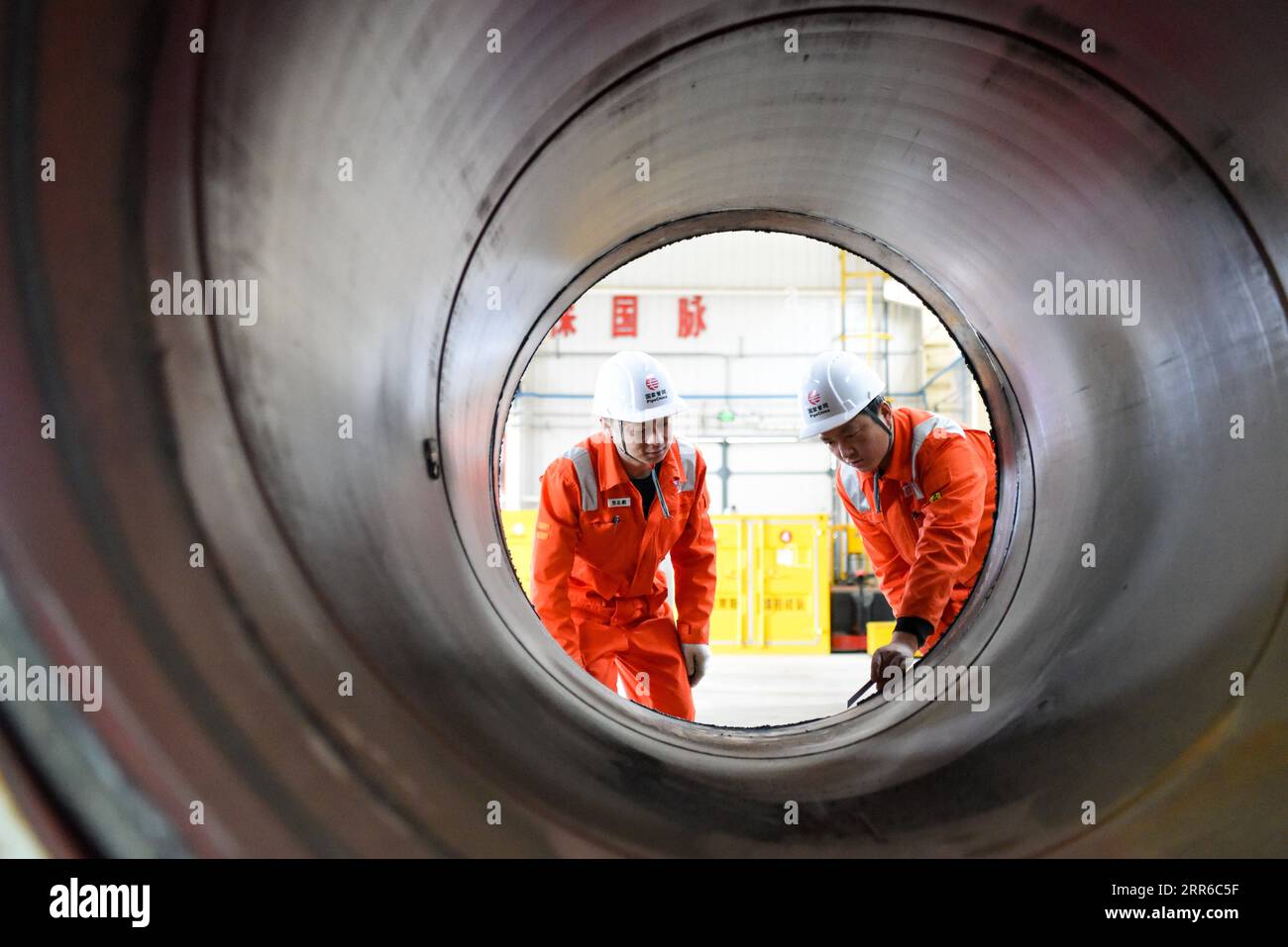 210205 -- HORGOS, Feb. 5, 2021 -- Maintenance workers exchange ideas on ...