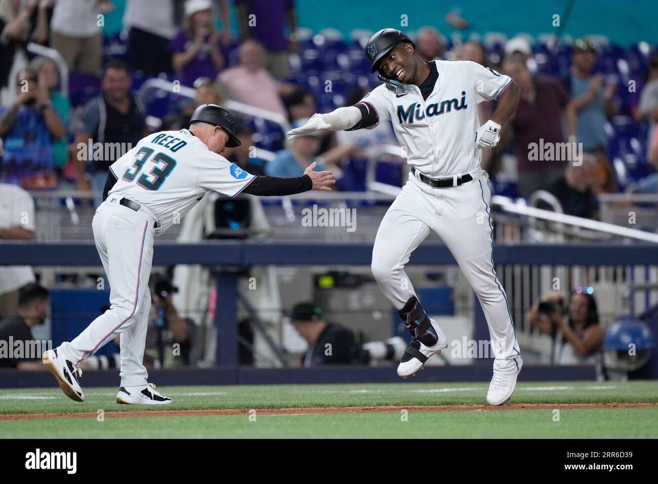 Miami Marlins' Jesus Sanchez, right, celebrates with third base/infield ...