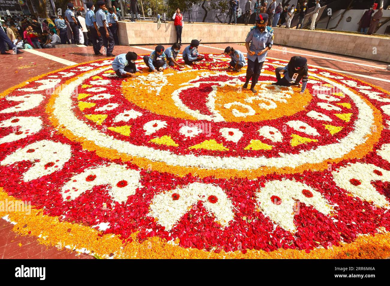 210221 -- DHAKA, Feb. 21, 2021 -- Volunteers arrange the decoration in ...