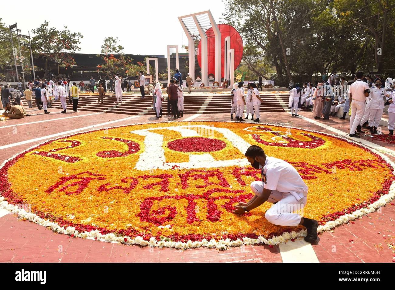 210221 -- DHAKA, Feb. 21, 2021 -- A volunteer arranges the decoration ...