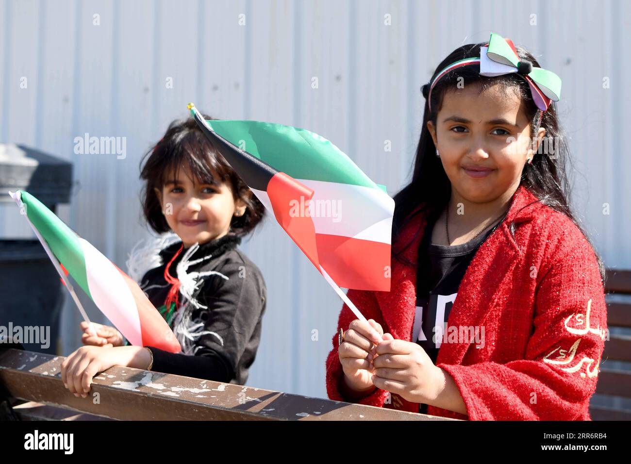 210225 -- KUWAIT CITY, Feb. 25, 2021 -- Girls holding Kuwaiti flags are ...
