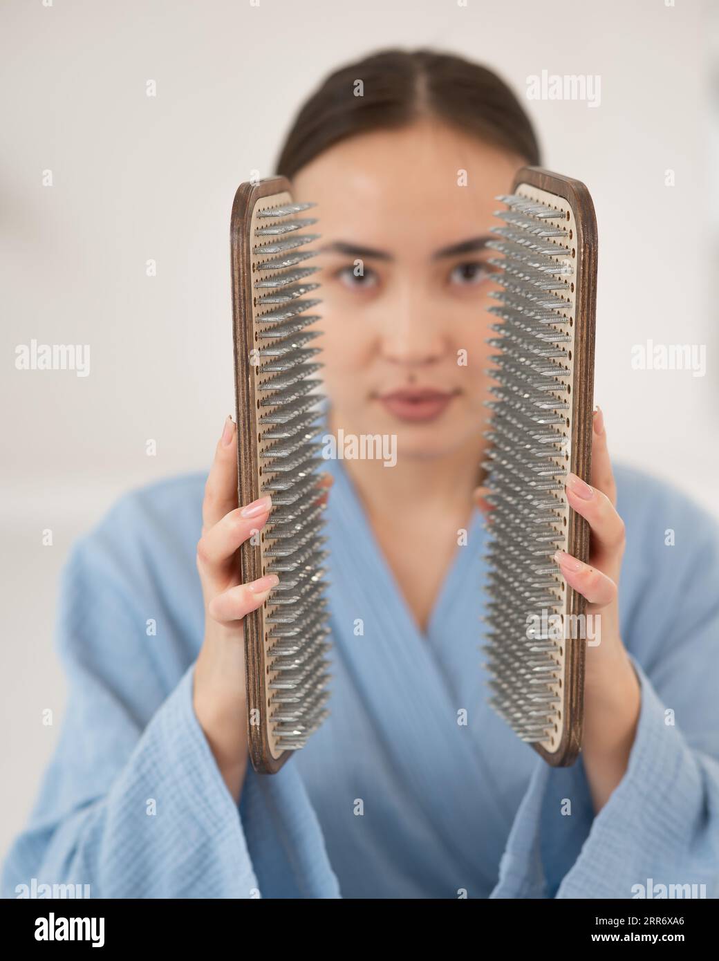 Asian woman holding sadhu boards on face background Stock Photo - Alamy