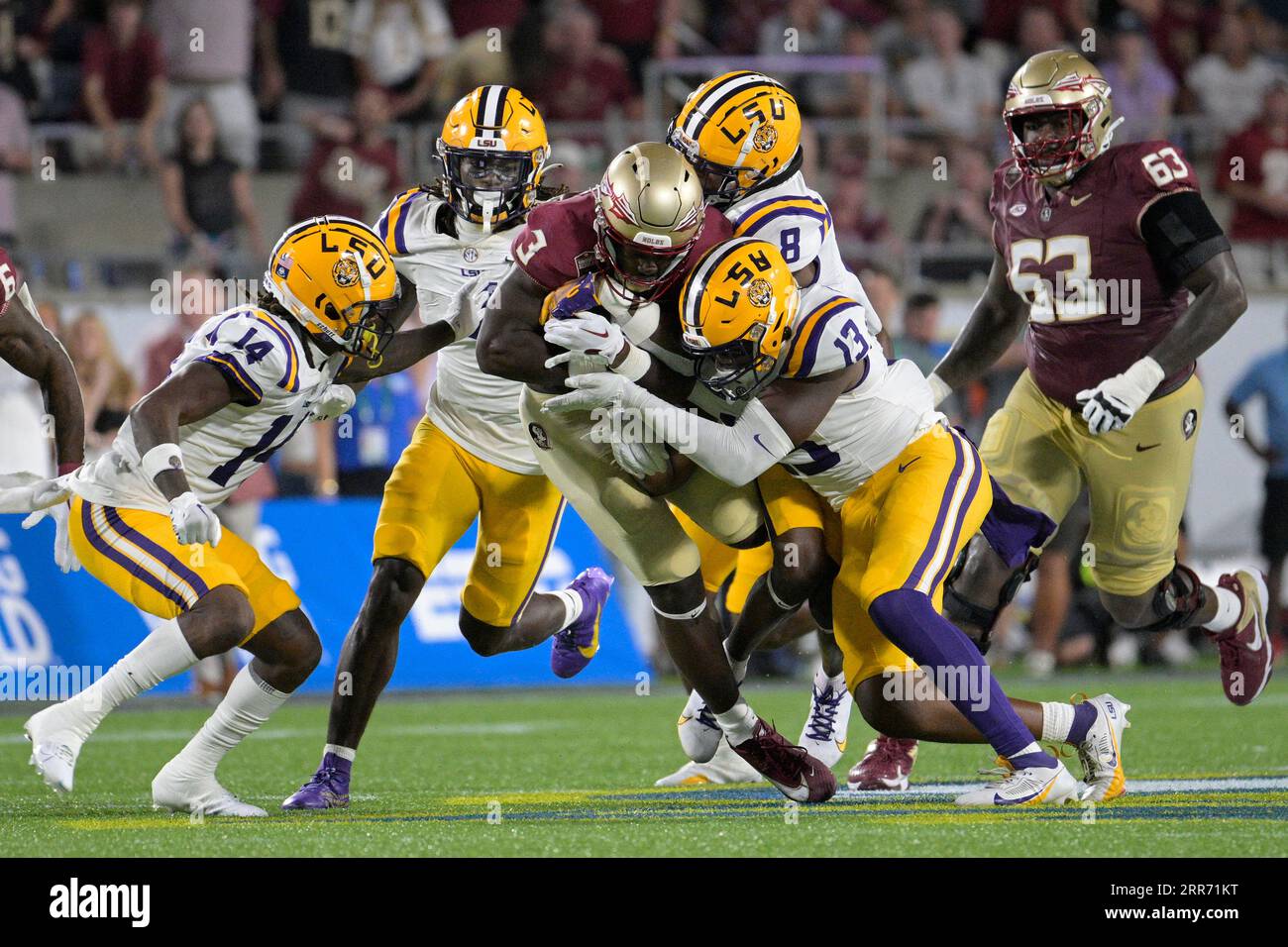 Florida State running back Trey Benson (3) is tackled by LSU safety ...