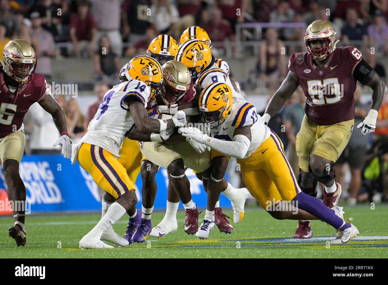 Florida State running back Trey Benson (3) is tackled by LSU safety ...