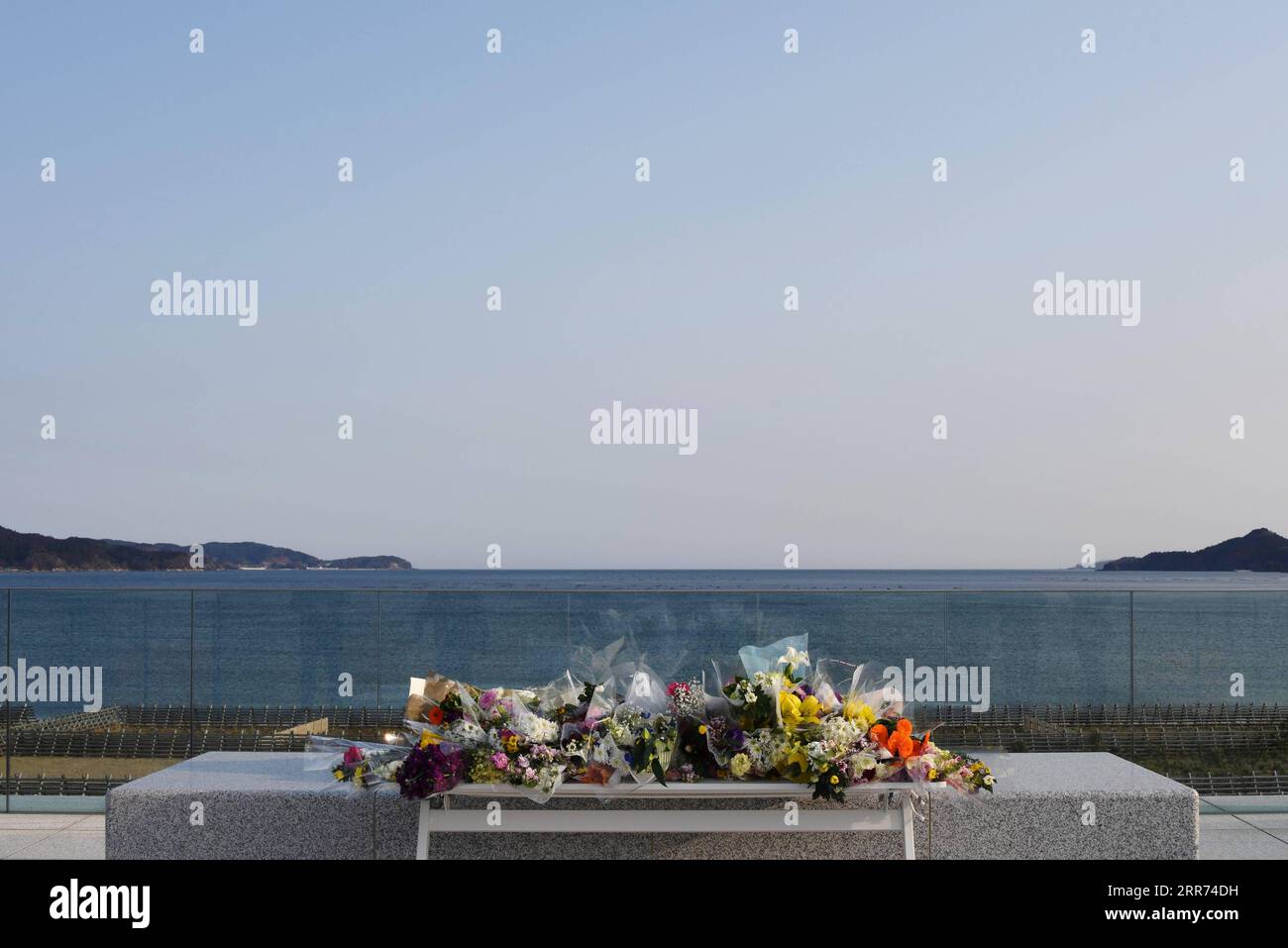 210311 -- TOKYO, March 11, 2021 -- Flowers are seen to commemorate ...