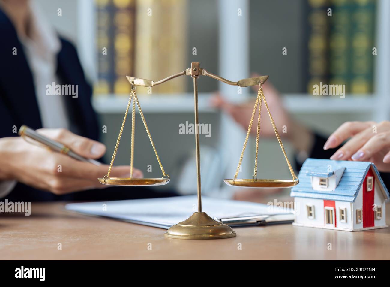 lawyer and client meeting and talking at office table with the scale of ...