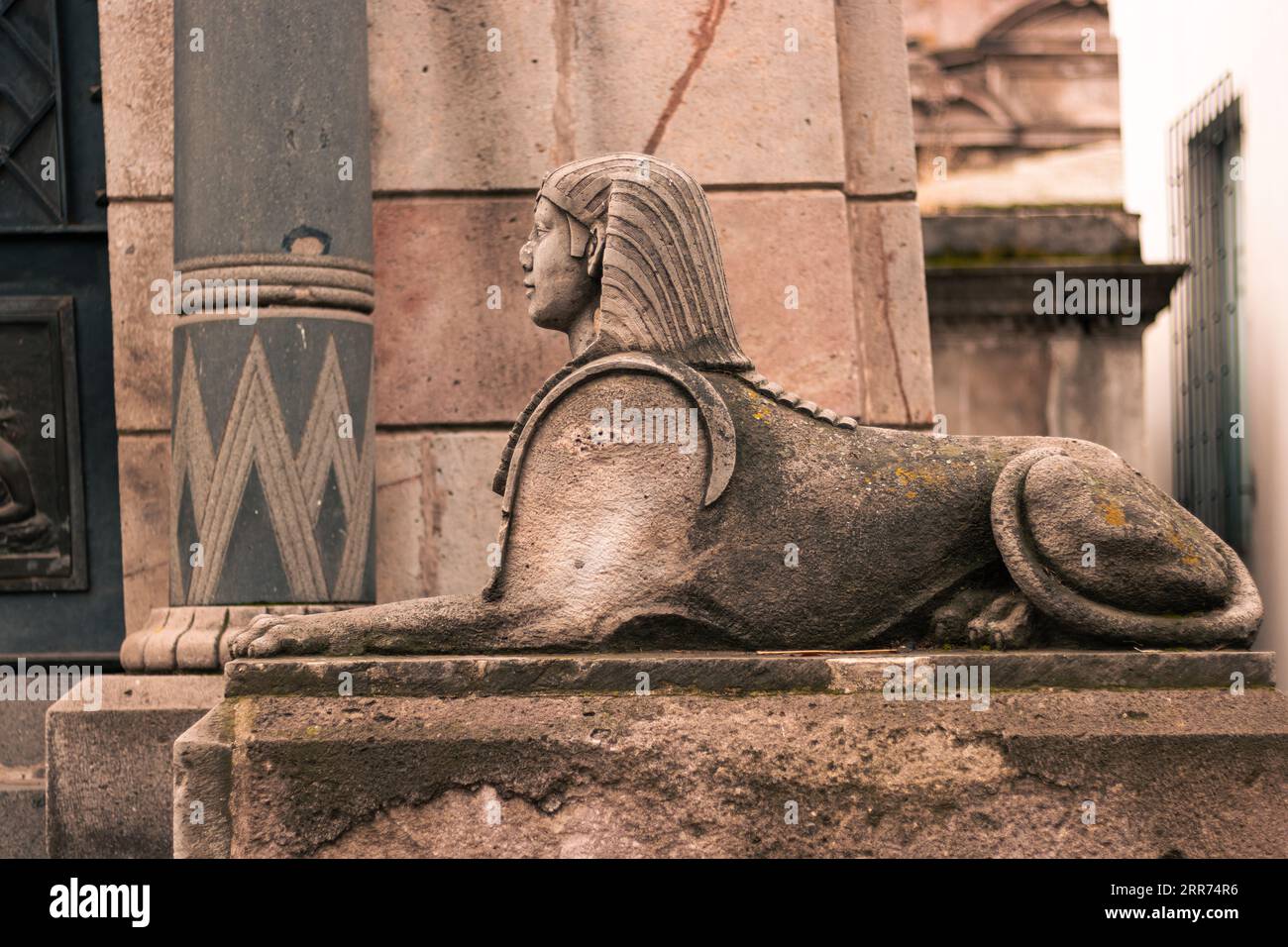 figure statue of a sphinx in an outdoor cemetery park with natural ...