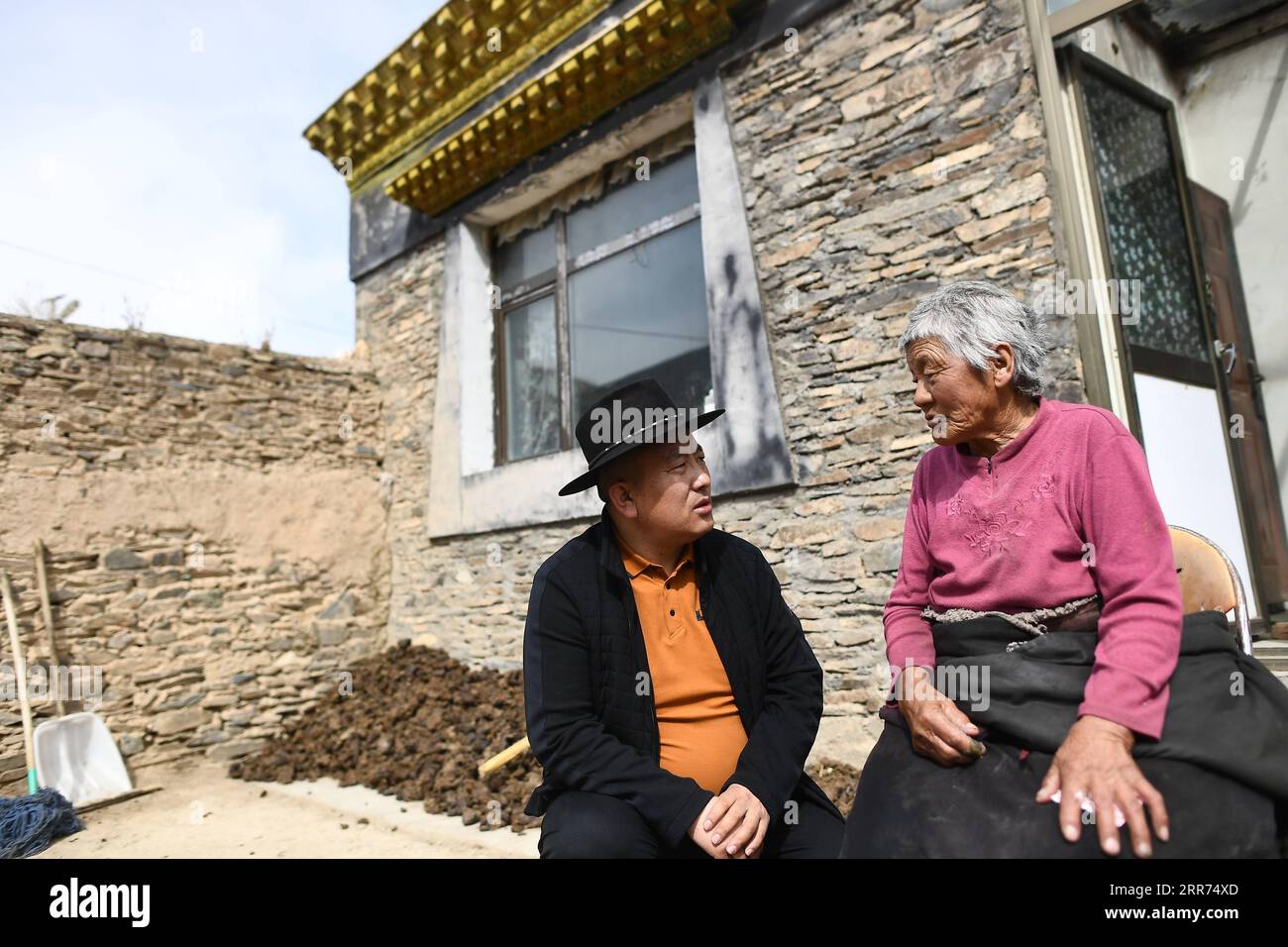 210312 -- YUSHU, March 12, 2021 -- Nyima L talks with an elderly woman ...