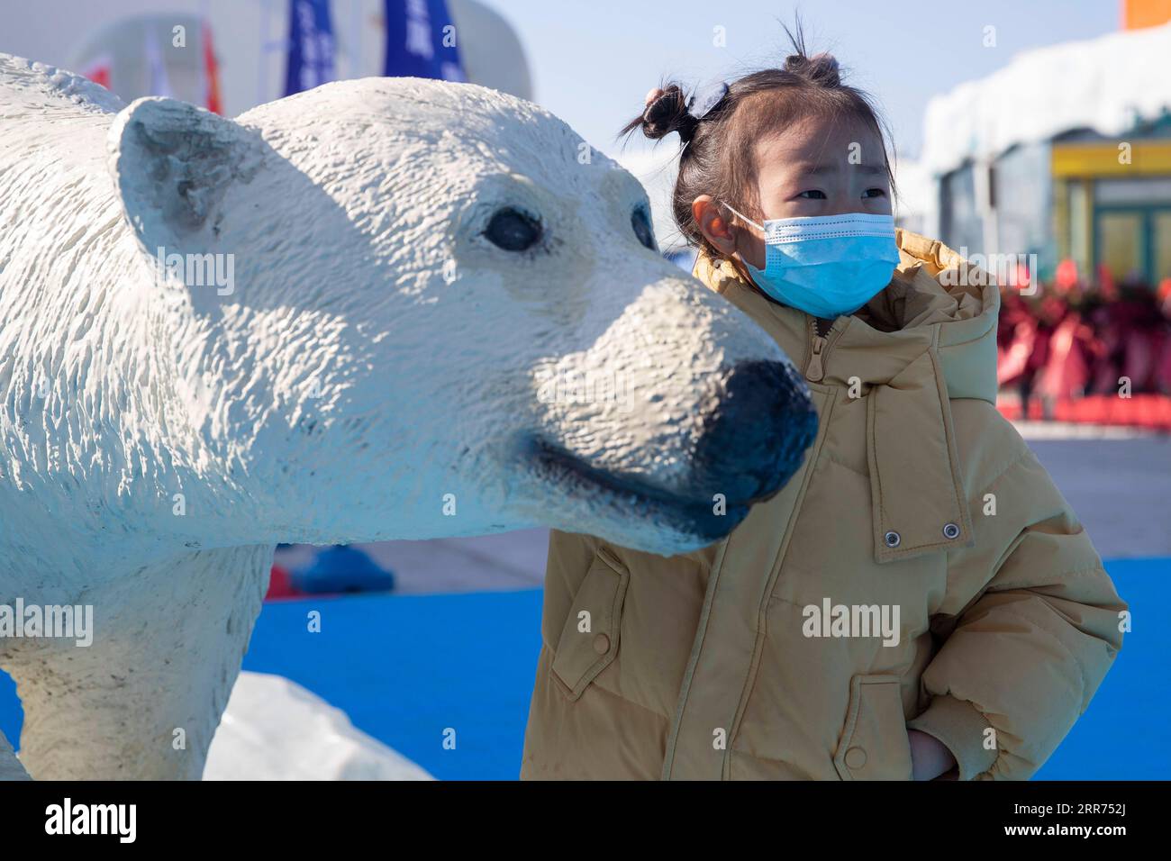210312 -- HARBIN, March 12, 2021 -- A girl poses for a picture with a ...