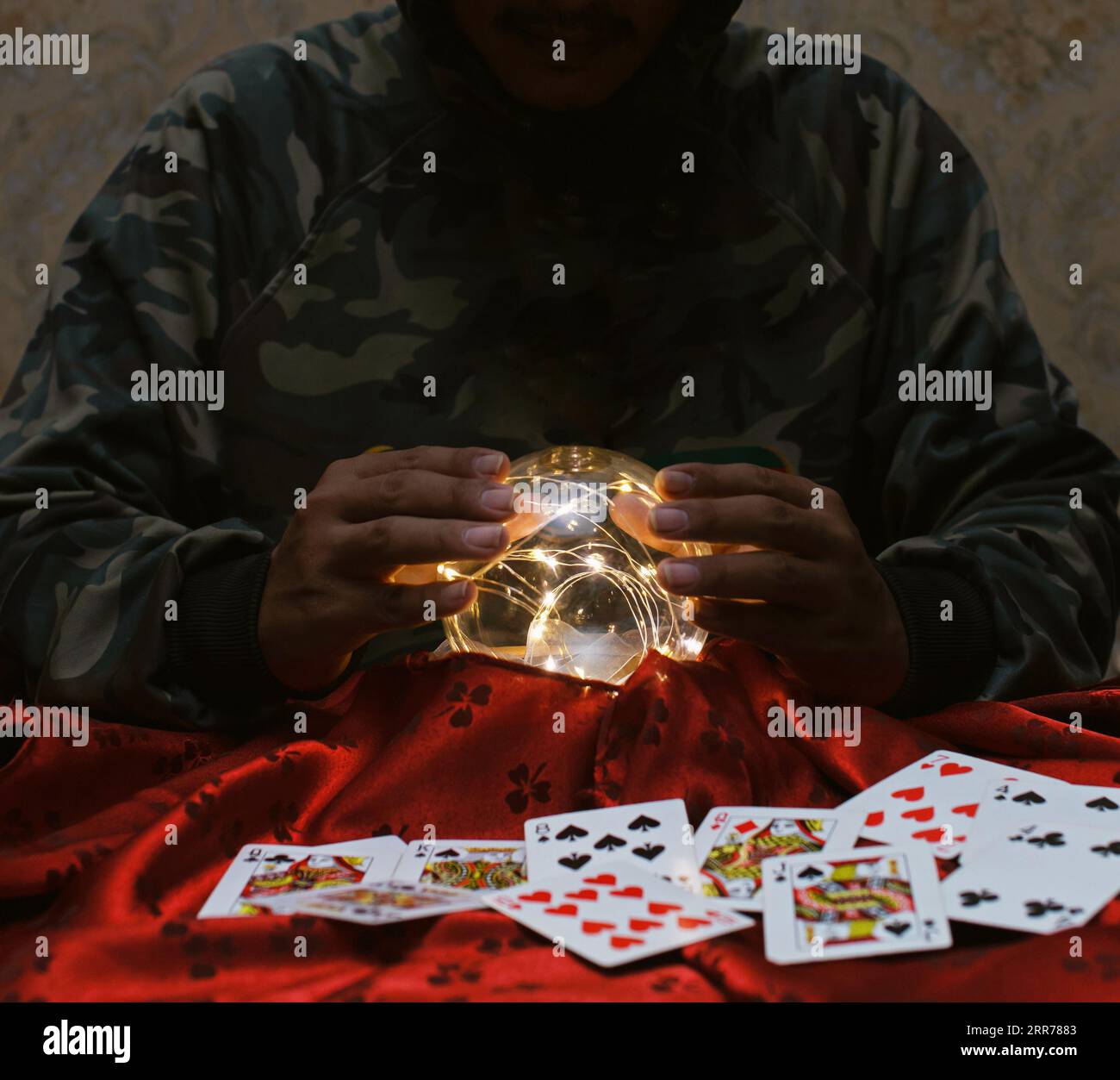 A fortune teller man is predicting the future with a crystal ball on a ...