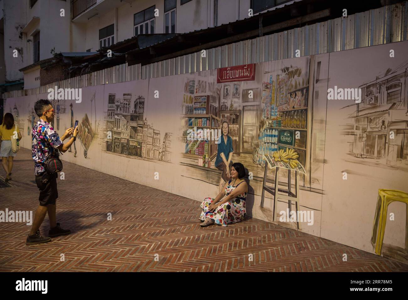 210320 -- BANGKOK, March 20, 2021 -- Tourists take photos with graffiti ...