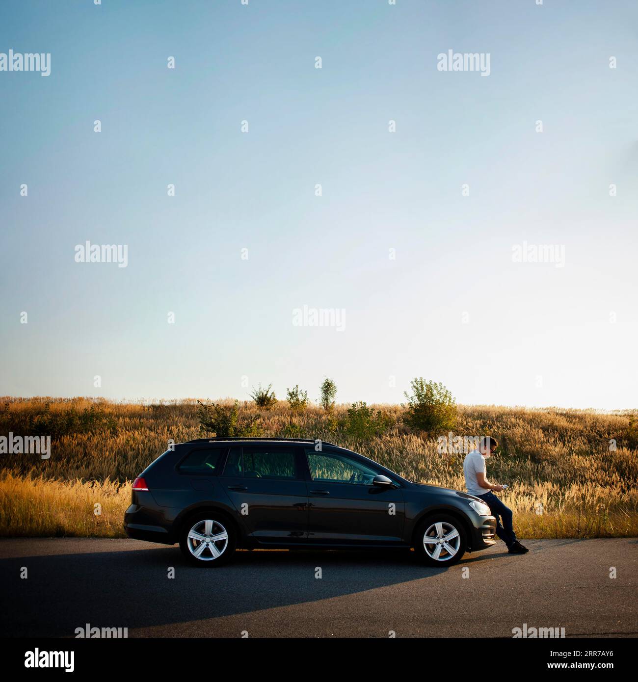 Man sitting car hood Stock Photo - Alamy Man sitting car hood Stock Photo - Alamy