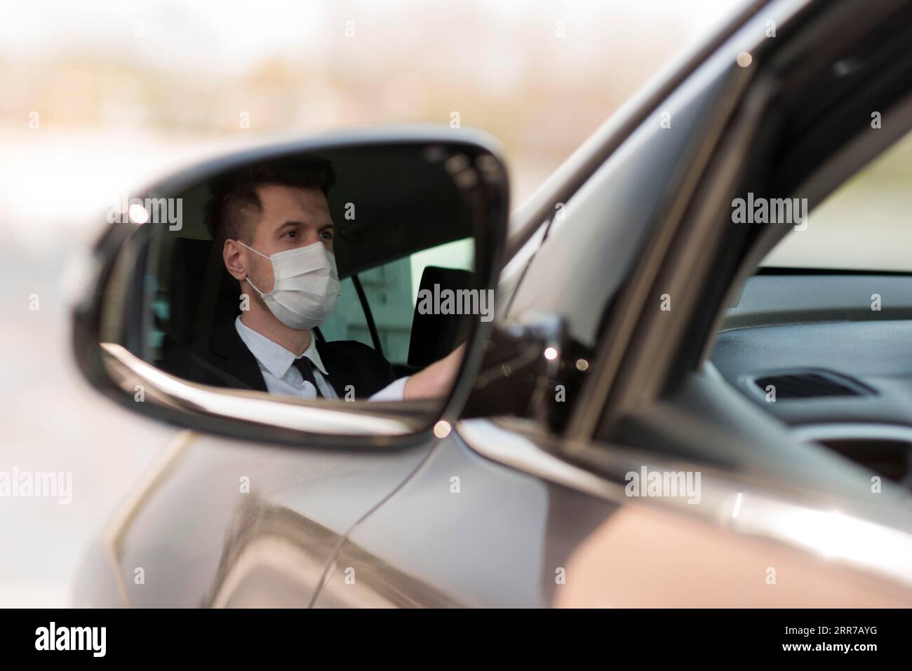Man car mirror with mask Stock Photo - Alamy