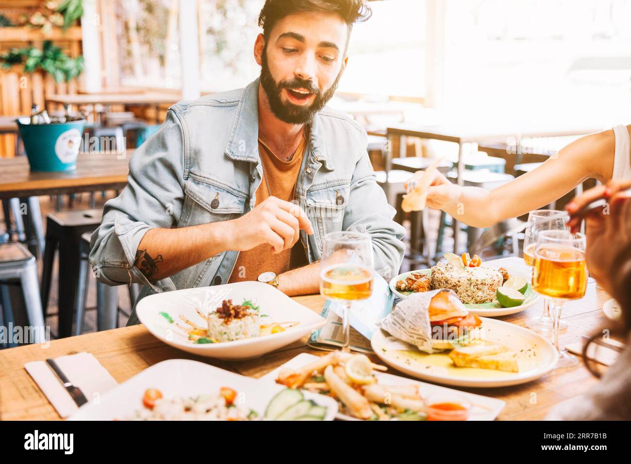 Man eating different dishes food Stock Photo - Alamy