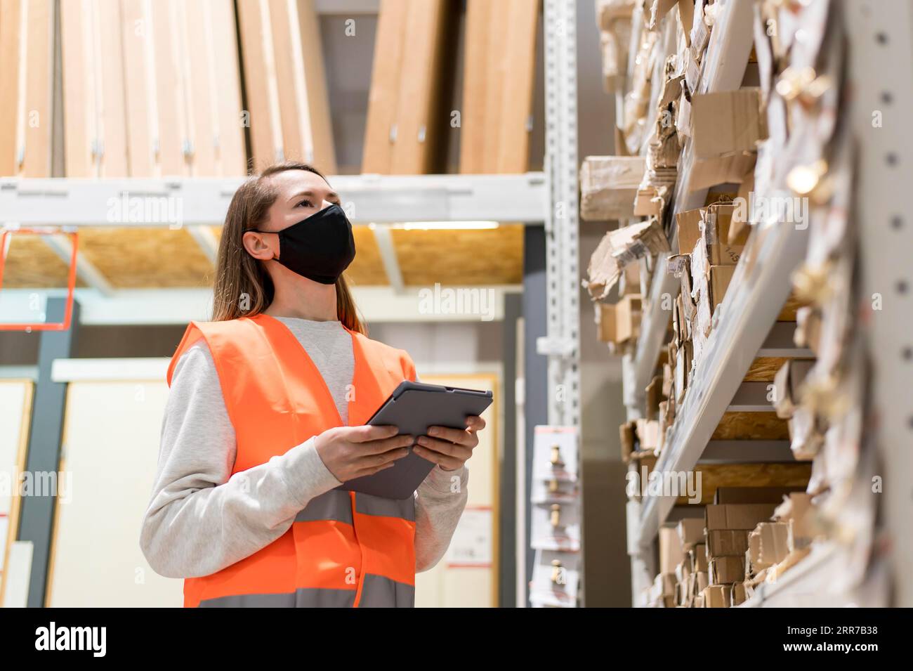 Medium shot woman wearing mask job Stock Photo - Alamy