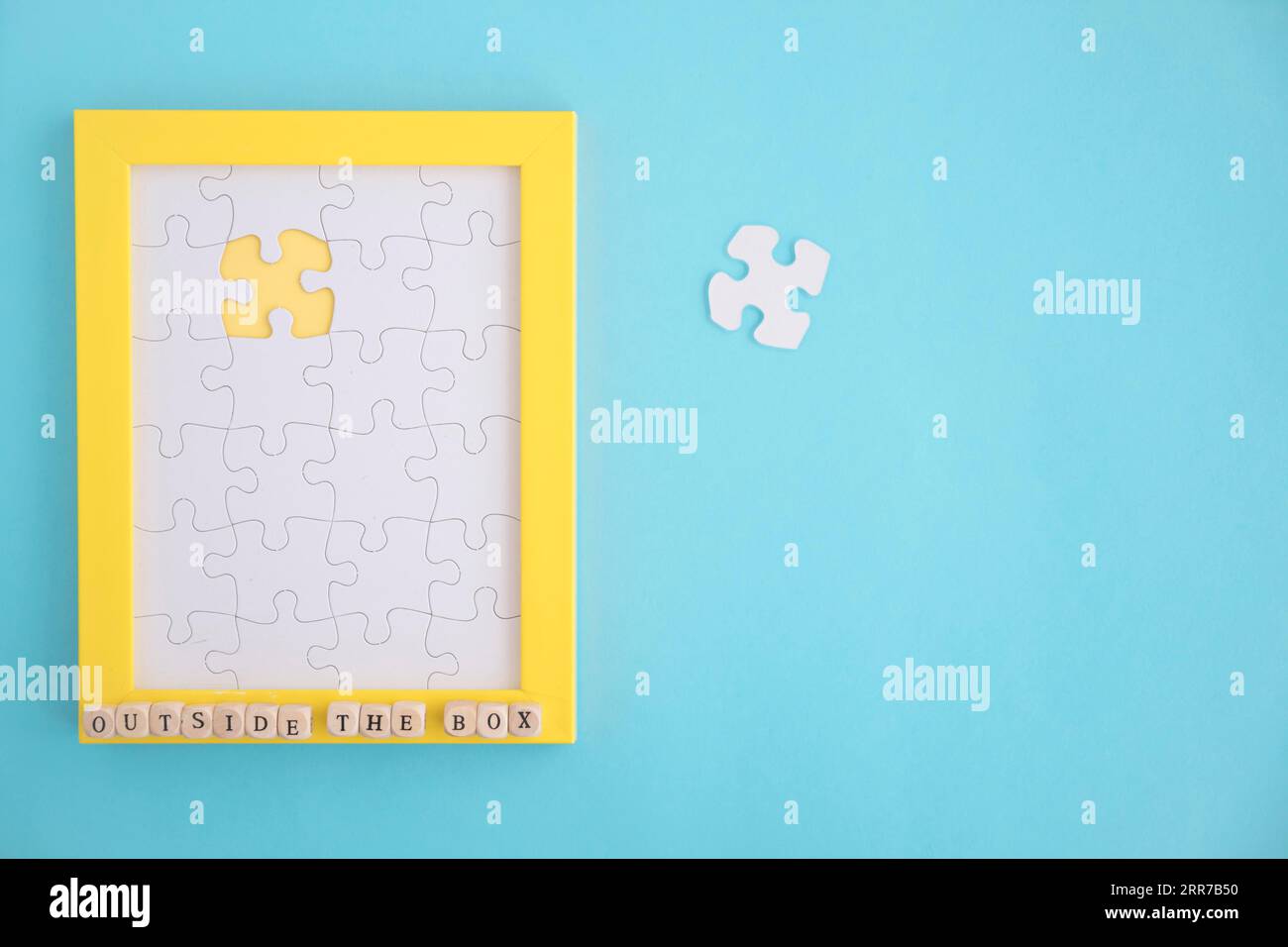 Missing white jigsaw puzzle frame blue background Stock Photo - Alamy