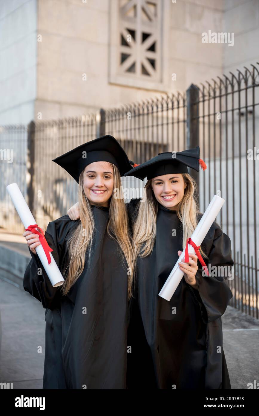 Medium shot college graduates smiling Stock Photo - Alamy