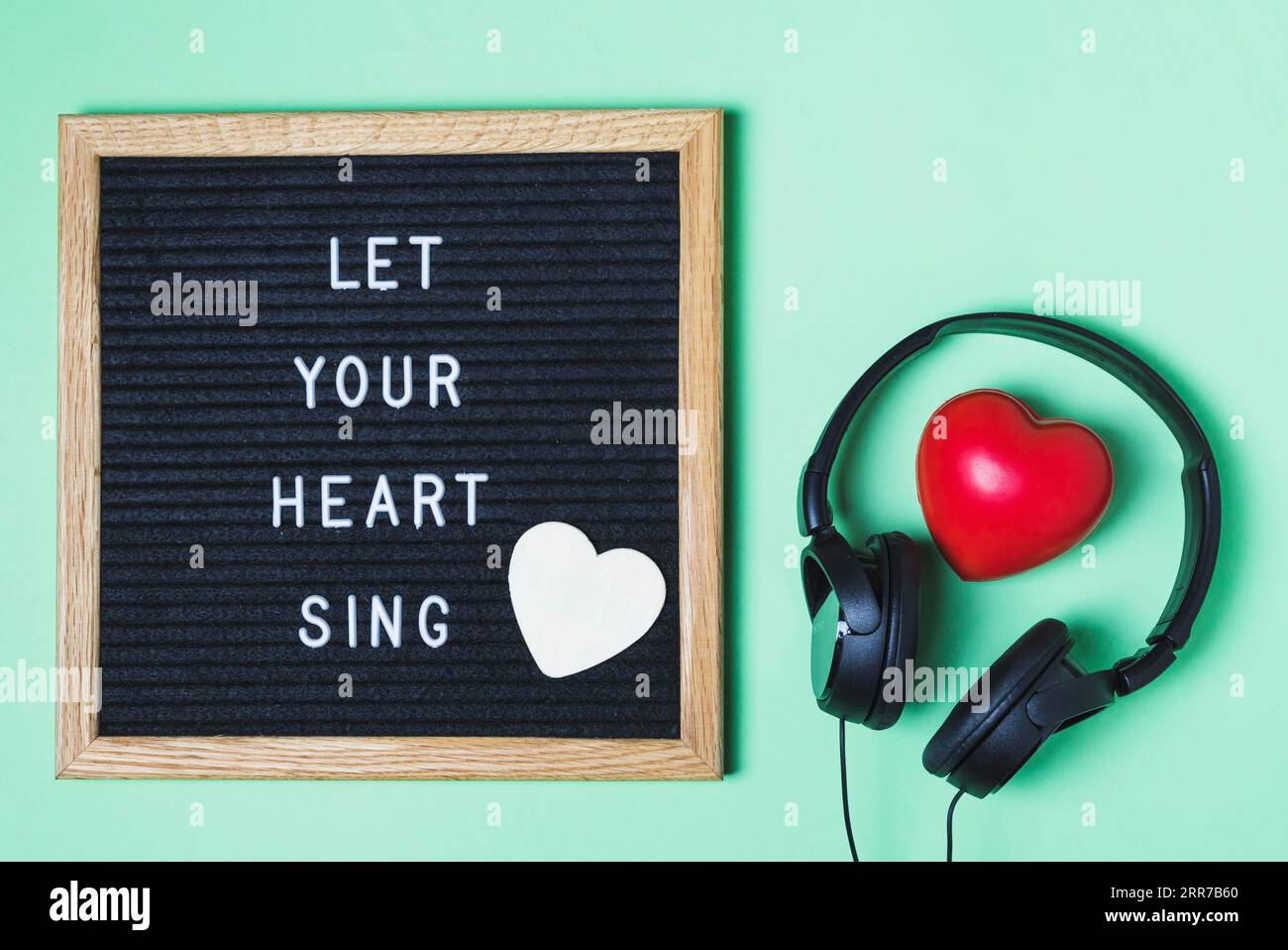 Message board red heart headphone green background Stock Photo - Alamy