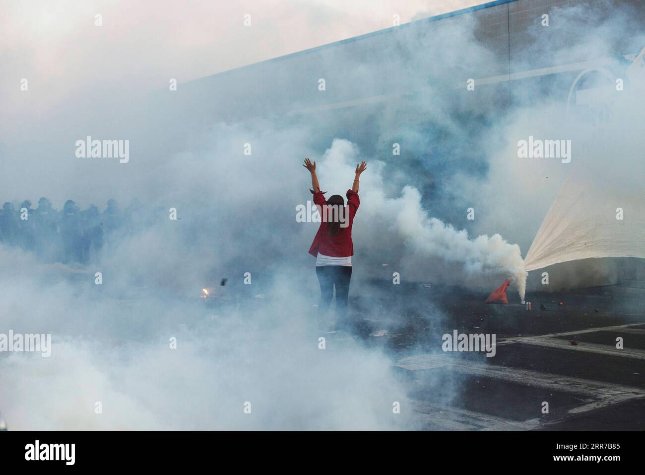 210324 -- BEIJING, March 24, 2021 -- A woman raises her arms as riot ...