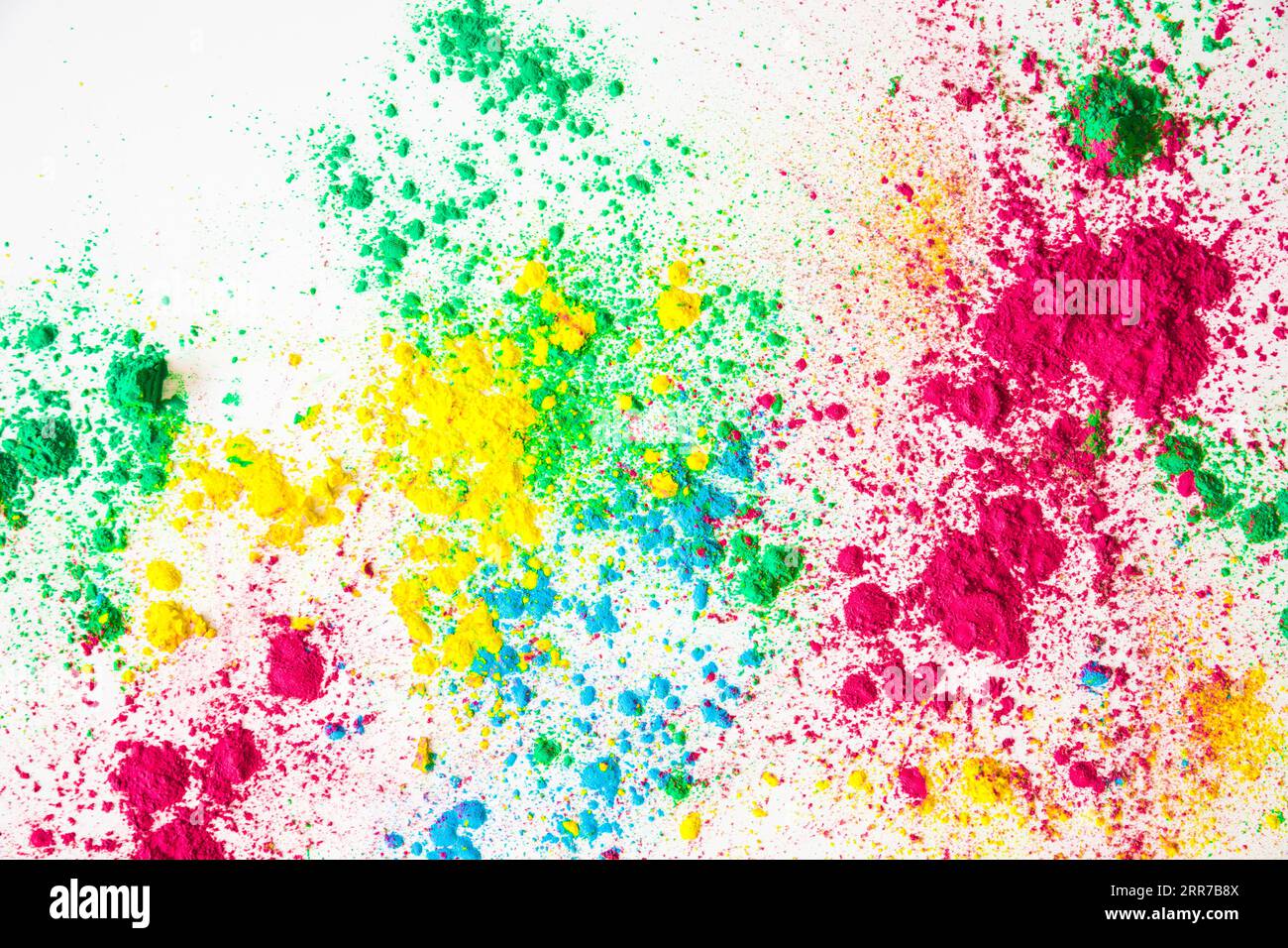 Overhead view holi powder white background Stock Photo - Alamy