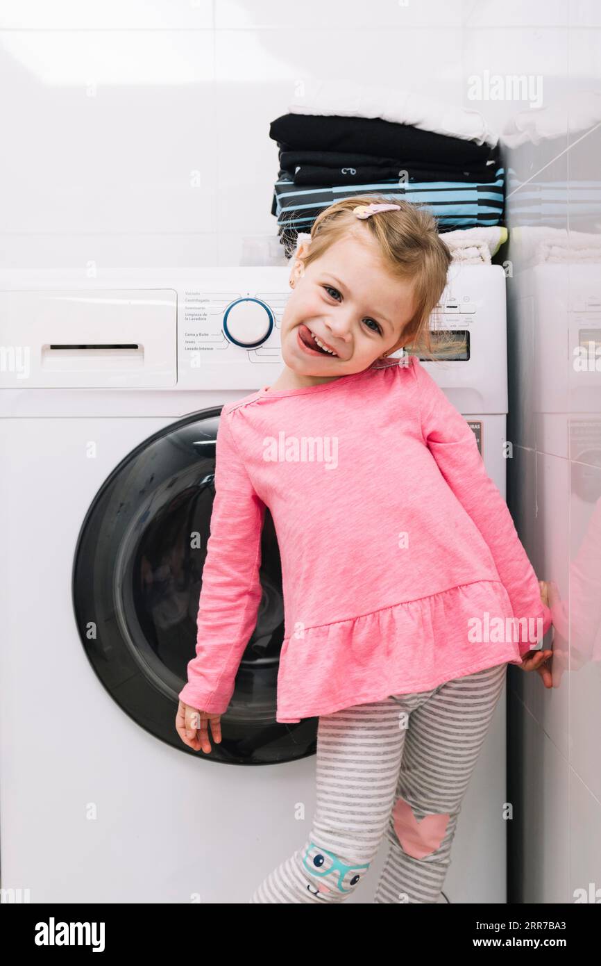 Child girl washing machine hi-res stock photography and images - Alamy