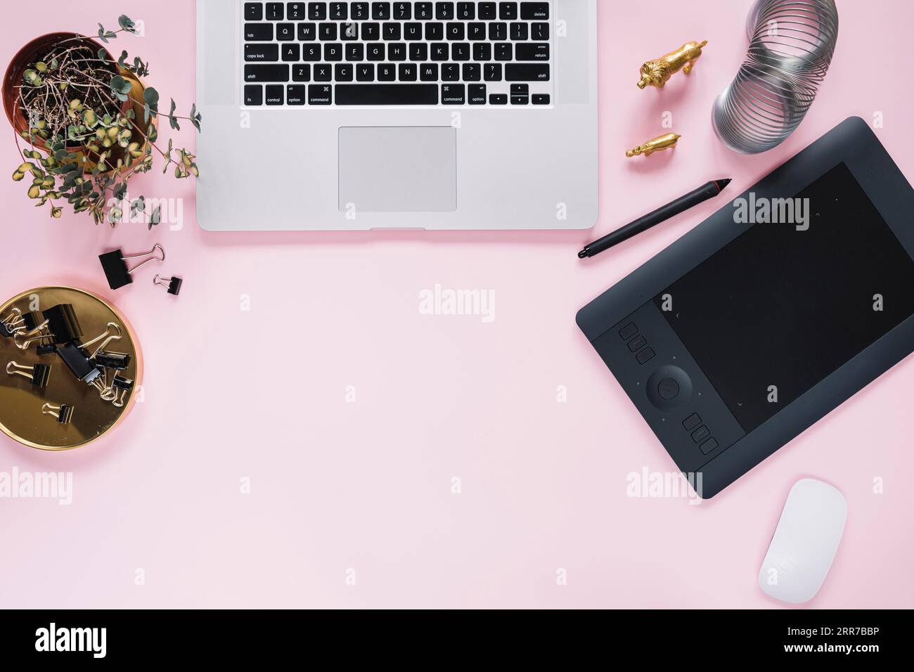 Overhead view open laptop with stationary pink backdrop Stock Photo - Alamy