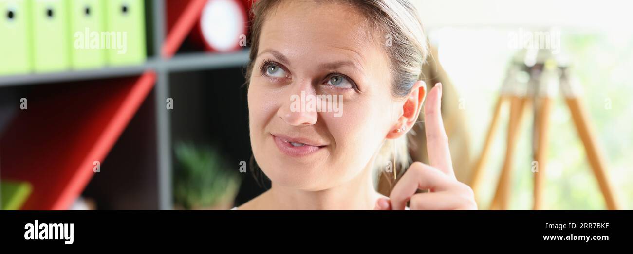 Woman pointing finger smiling hi-res stock photography and images - Alamy