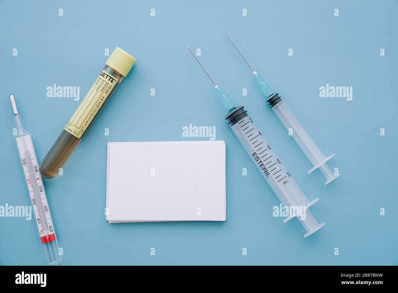 Syringes thermometer sample with business card Stock Photo - Alamy