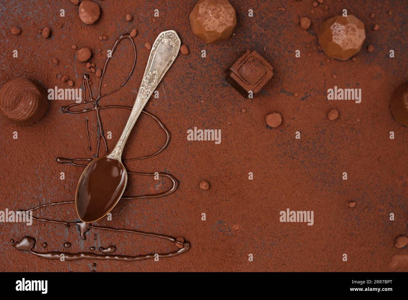 Spoon with chocolate syrup truffles cocoa powder Stock Photo - Alamy