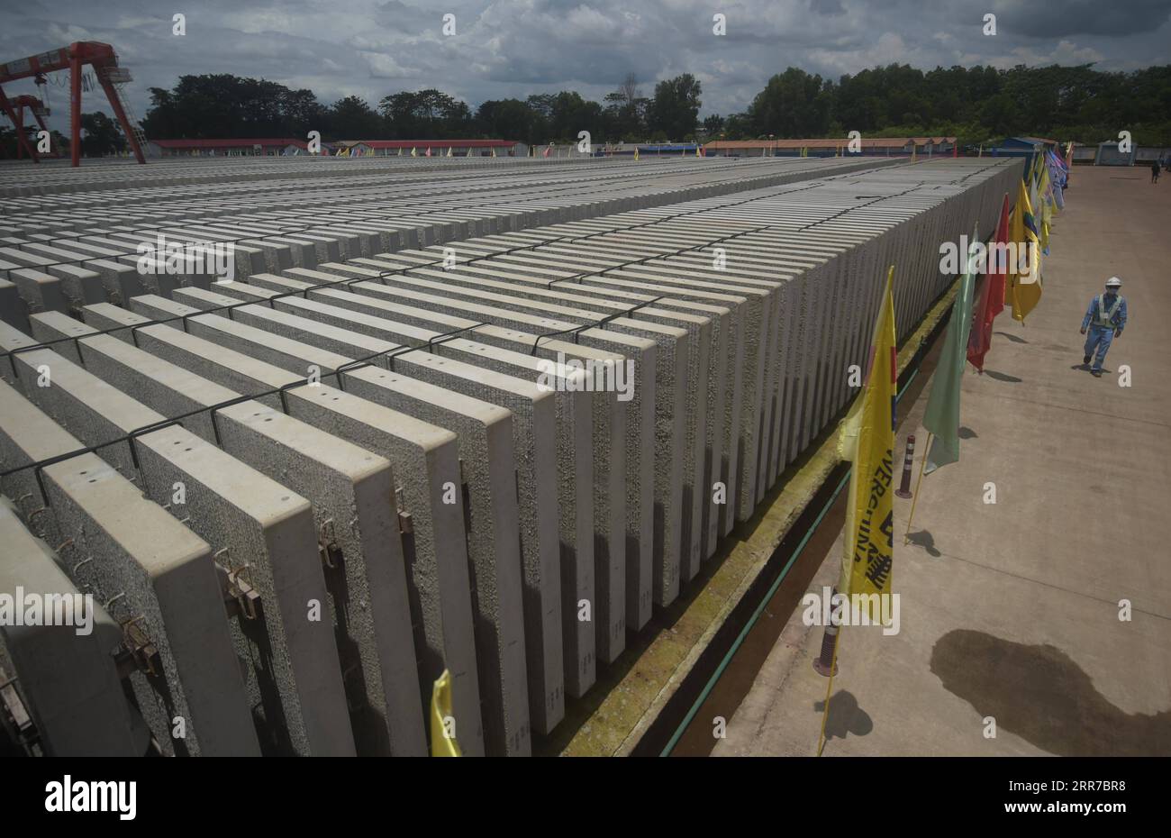 210325 -- JAKARTA, March 25, 2021 -- A worker walks passing lines of ...