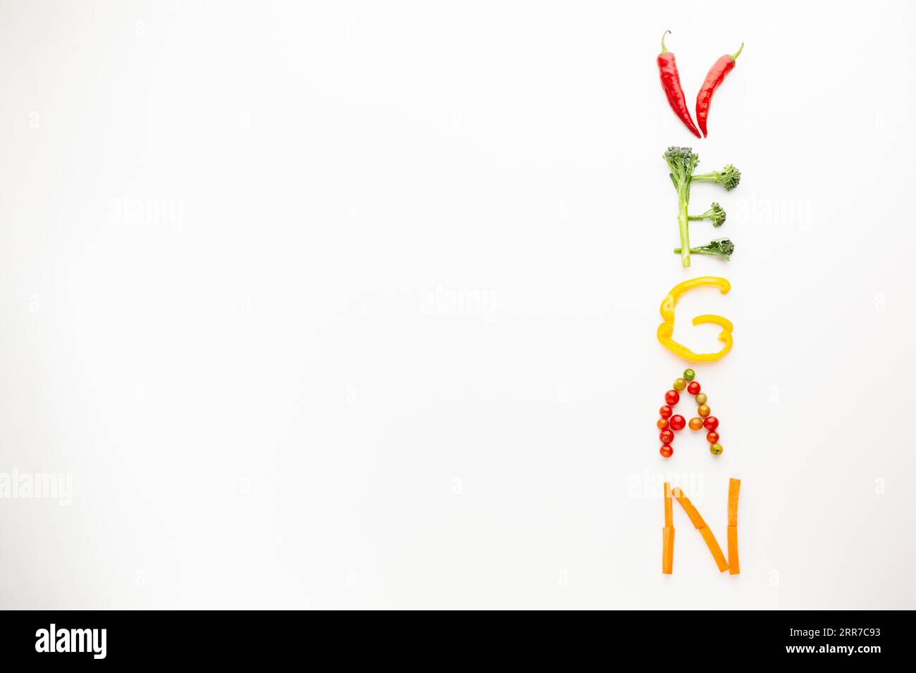 Vegan lettering made out vegetables with copy space Stock Photo - Alamy