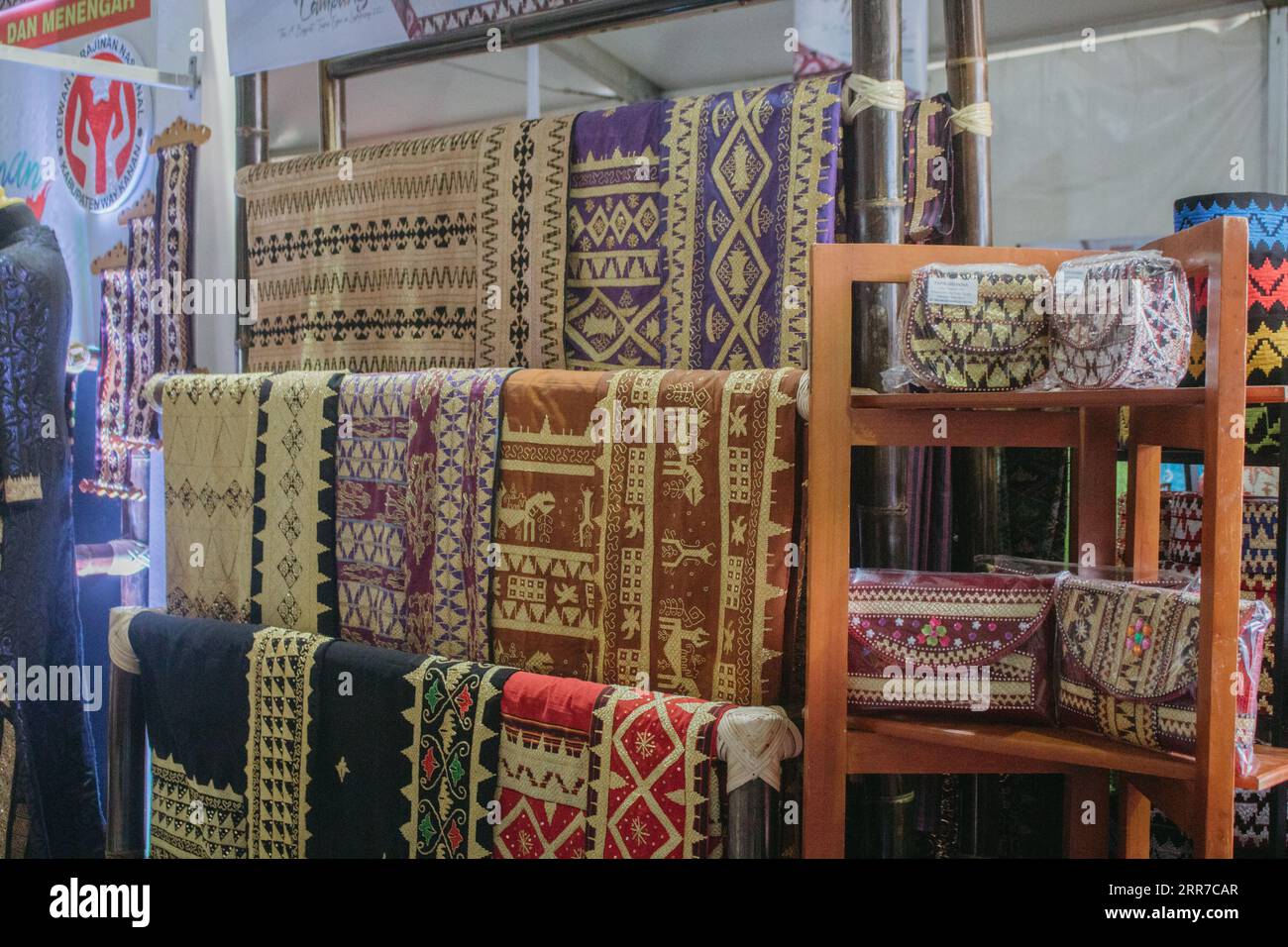 Fabric Various motifs. different fabrics displayed on the shelves. a ...