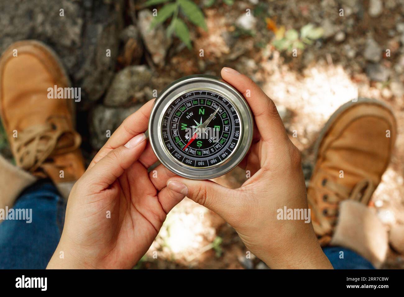 Top view woman holding compass Stock Photo - Alamy