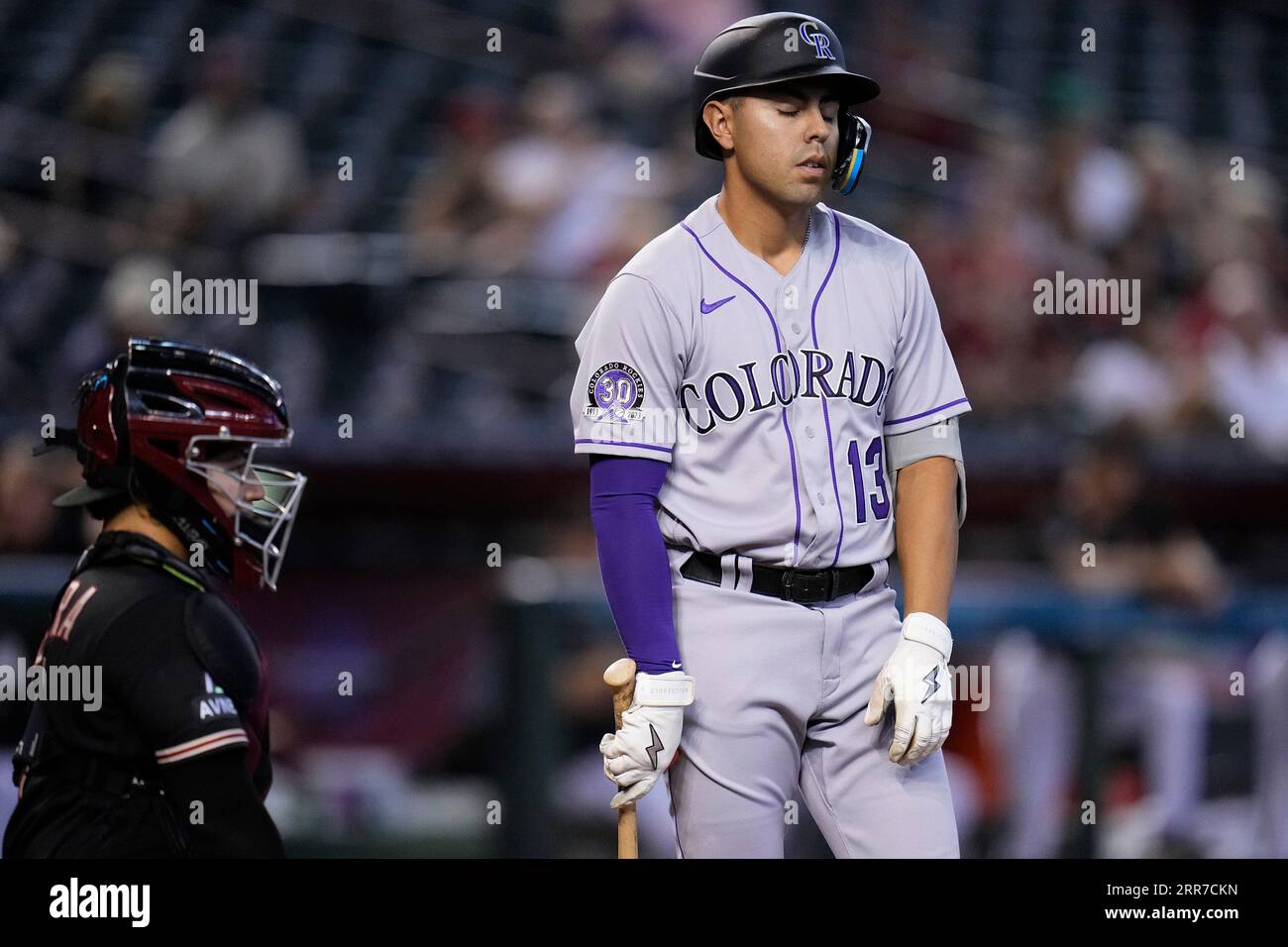 Colorado Rockies' Alan Trejo (13) pauses at home plate after striking ...