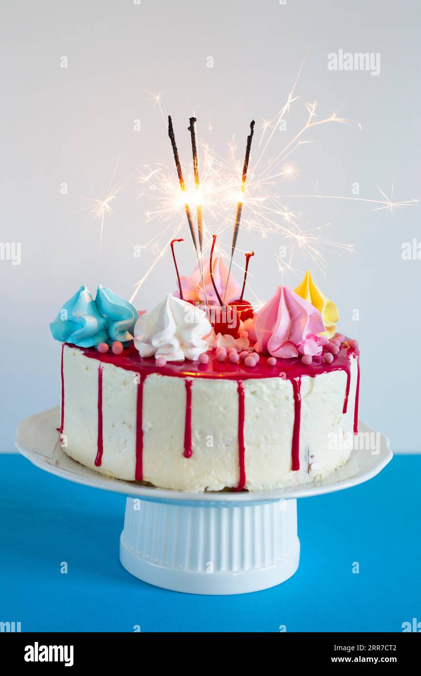 Birthday cake with lit fireworks Stock Photo - Alamy