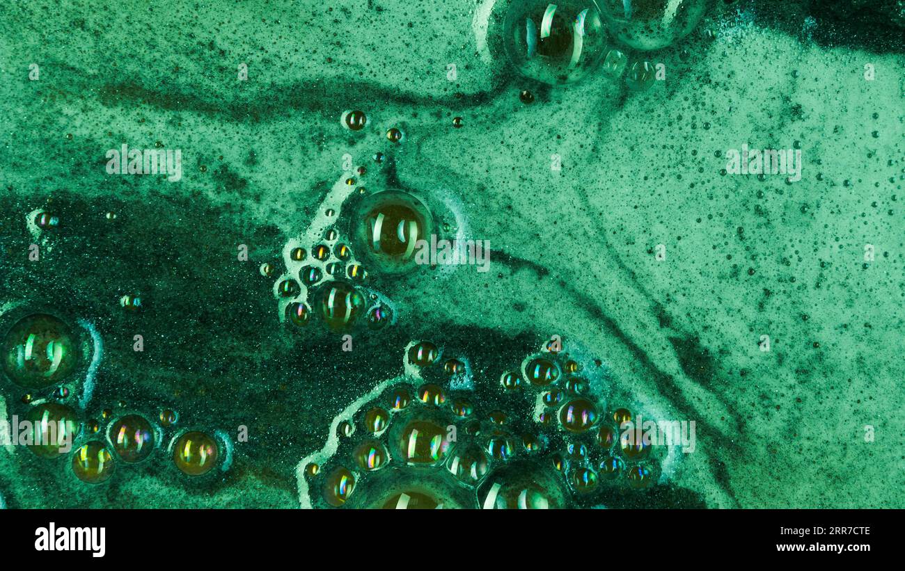 Boiling green liquid with foam blobs Stock Photo - Alamy