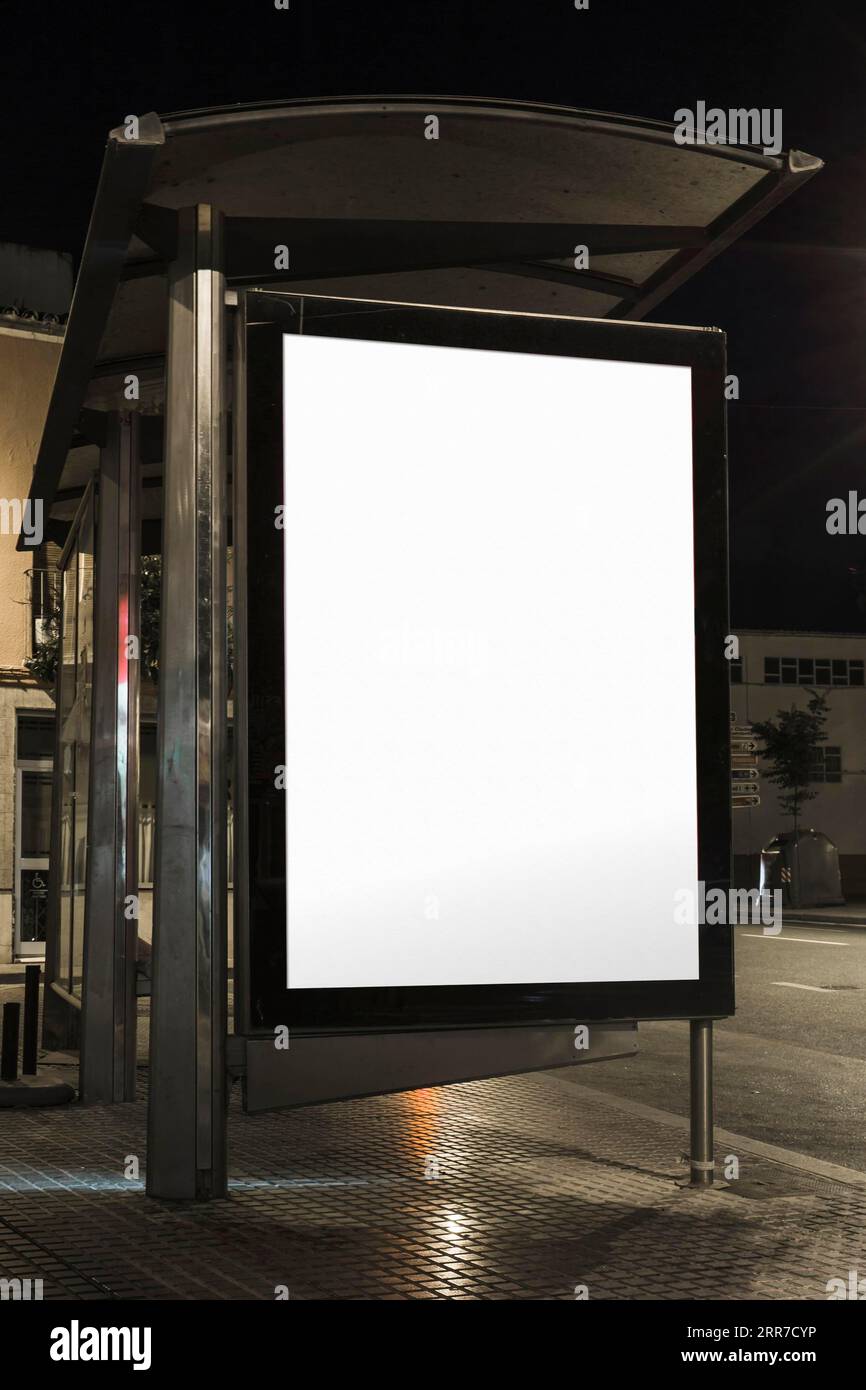 Bus shelter billboard night Stock Photo - Alamy