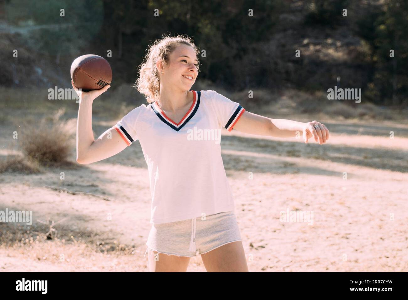 Cheerful teen schoolgirl playing rugby Stock Photo - Alamy