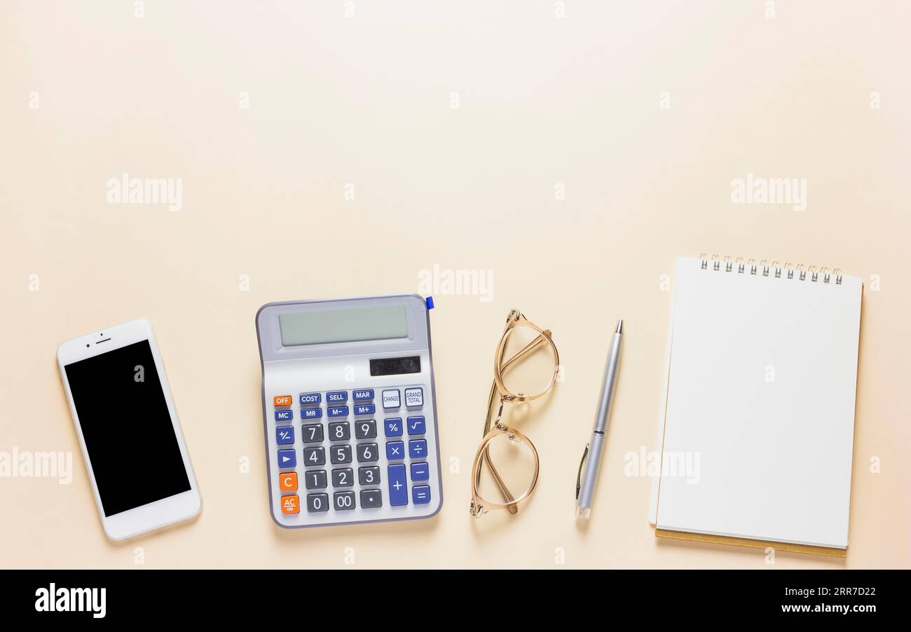 Calculator with smartphone table Stock Photo - Alamy