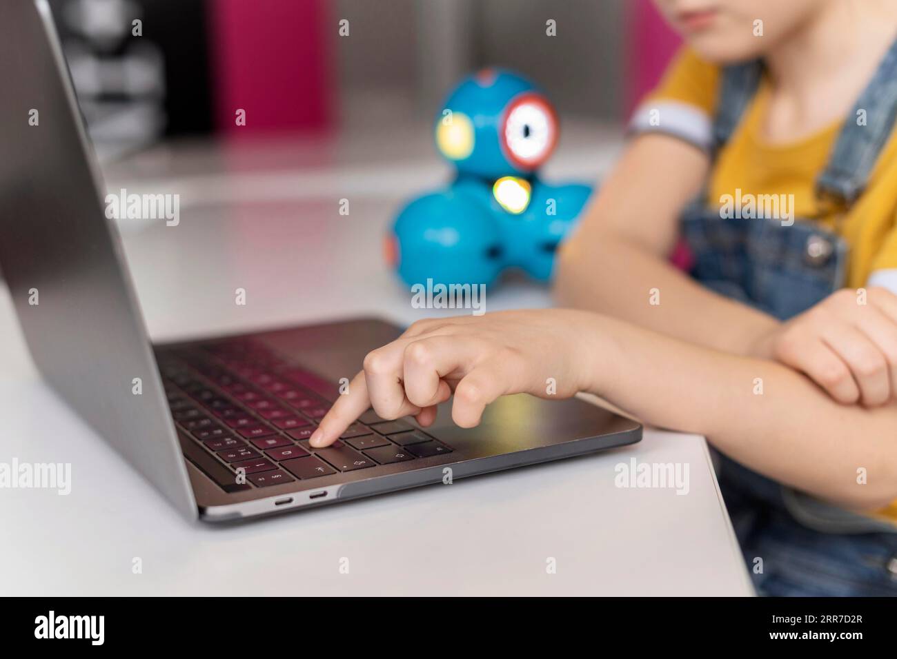 Kid typing keyboard Stock Photo - Alamy