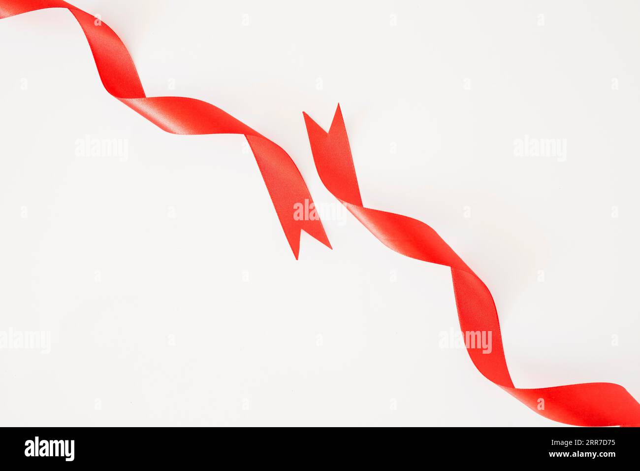 Curled red ribbons white background Stock Photo - Alamy