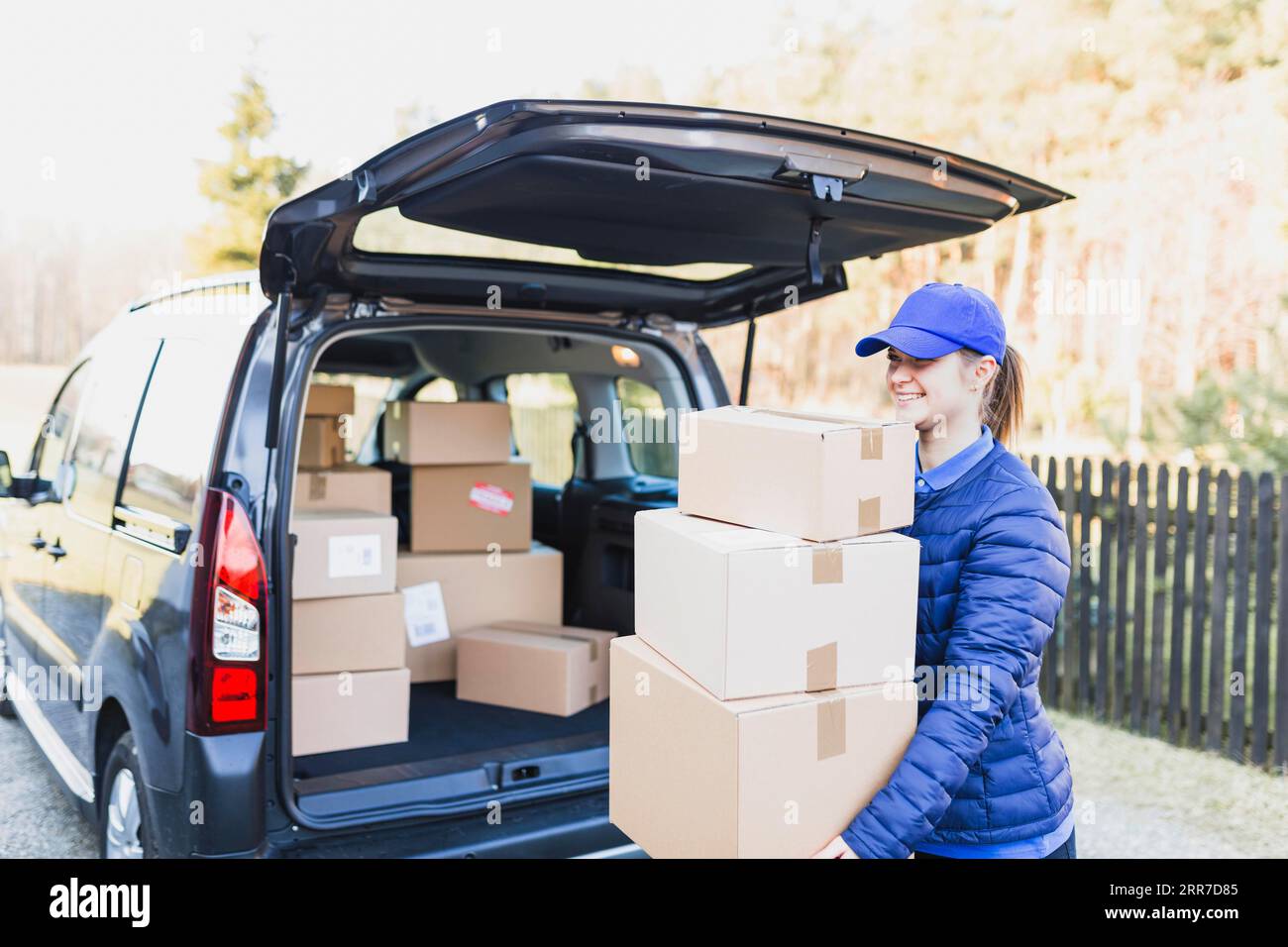 Courier carrying boxes customer Stock Photo - Alamy