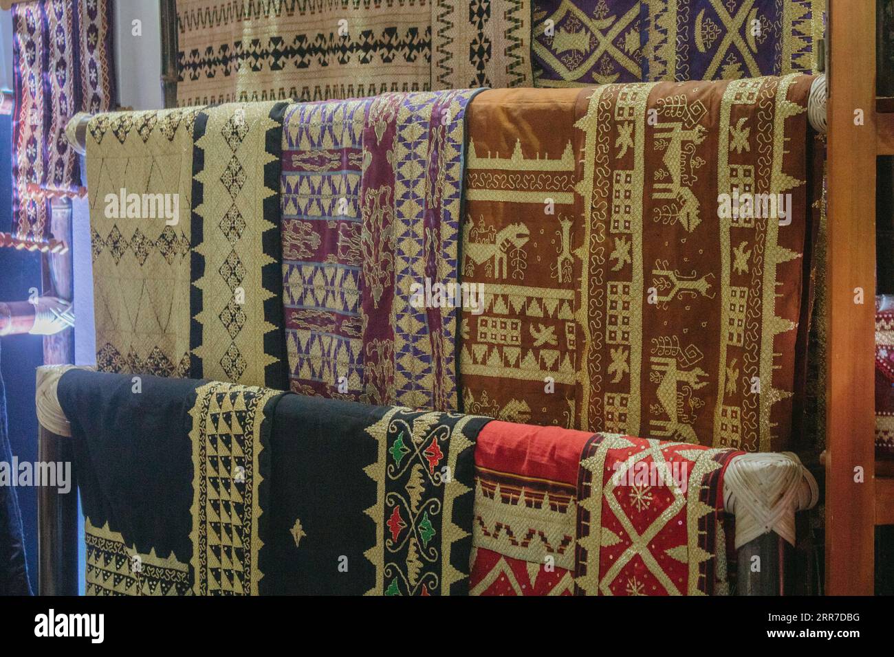 Fabric Various motifs. different fabrics displayed on the shelves. a ...