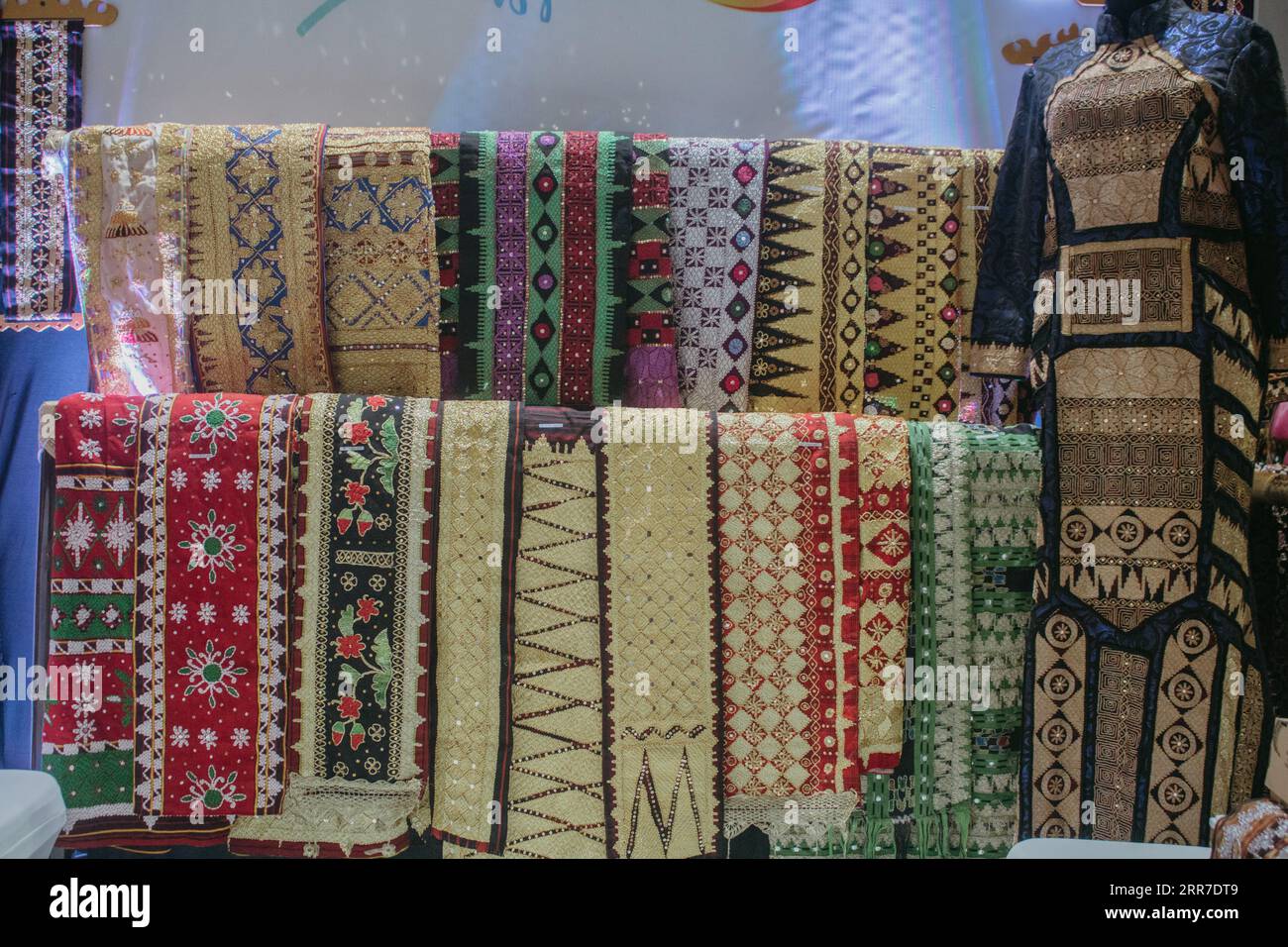 Fabric Various motifs. different fabrics displayed on the shelves. a ...