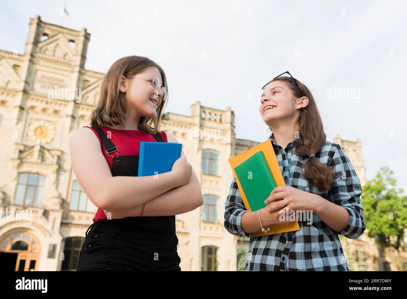 Low angle teenage girls talking Stock Photo - Alamy