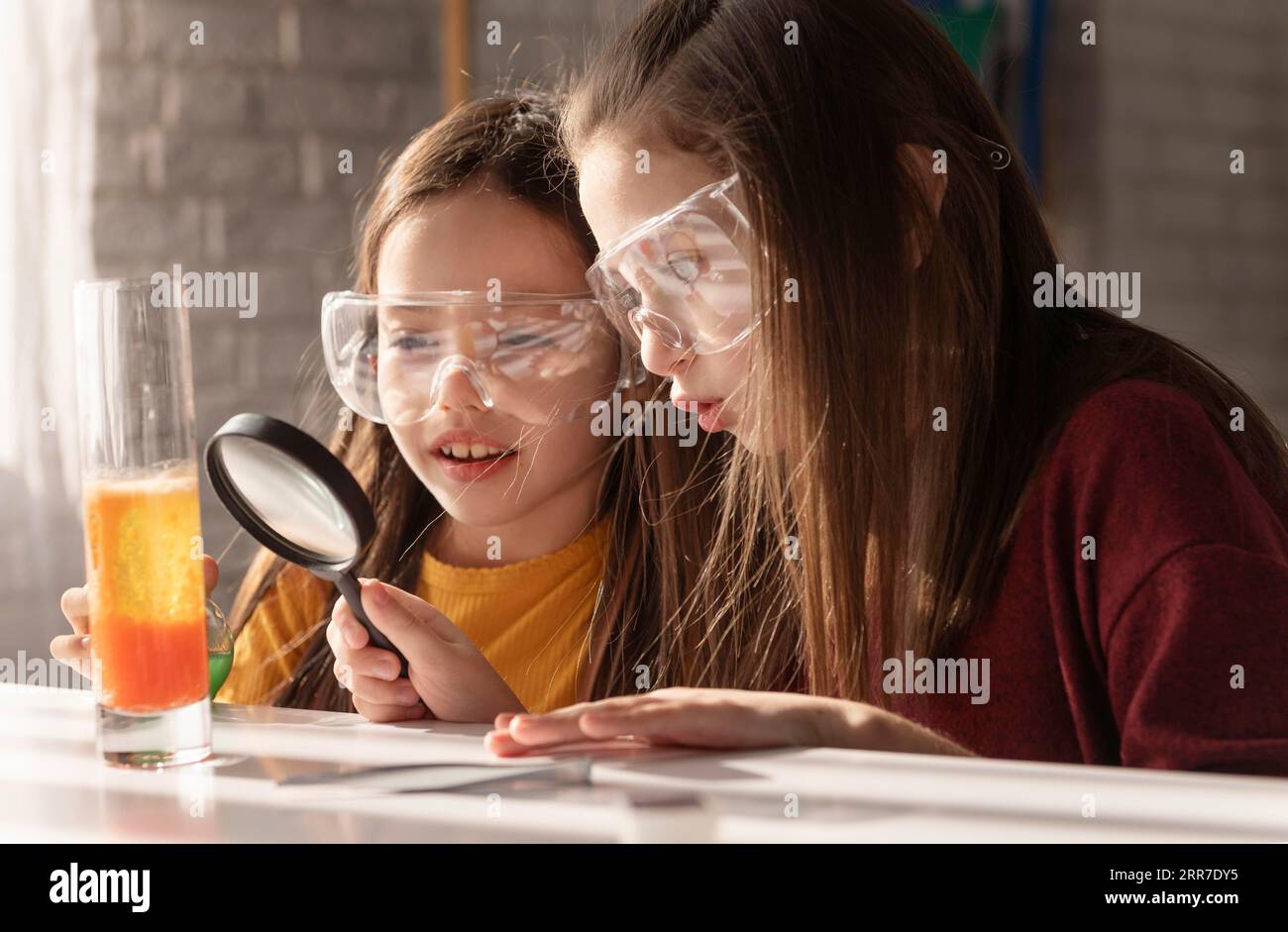 Girls with magnifying glass Stock Photo - Alamy