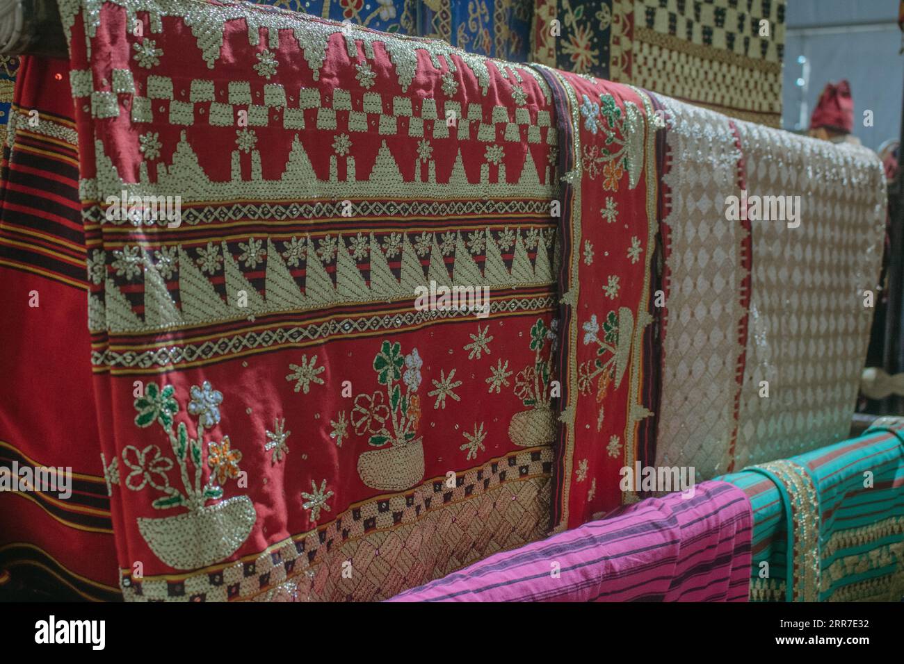 Fabric Various motifs. different fabrics displayed on the shelves. a ...