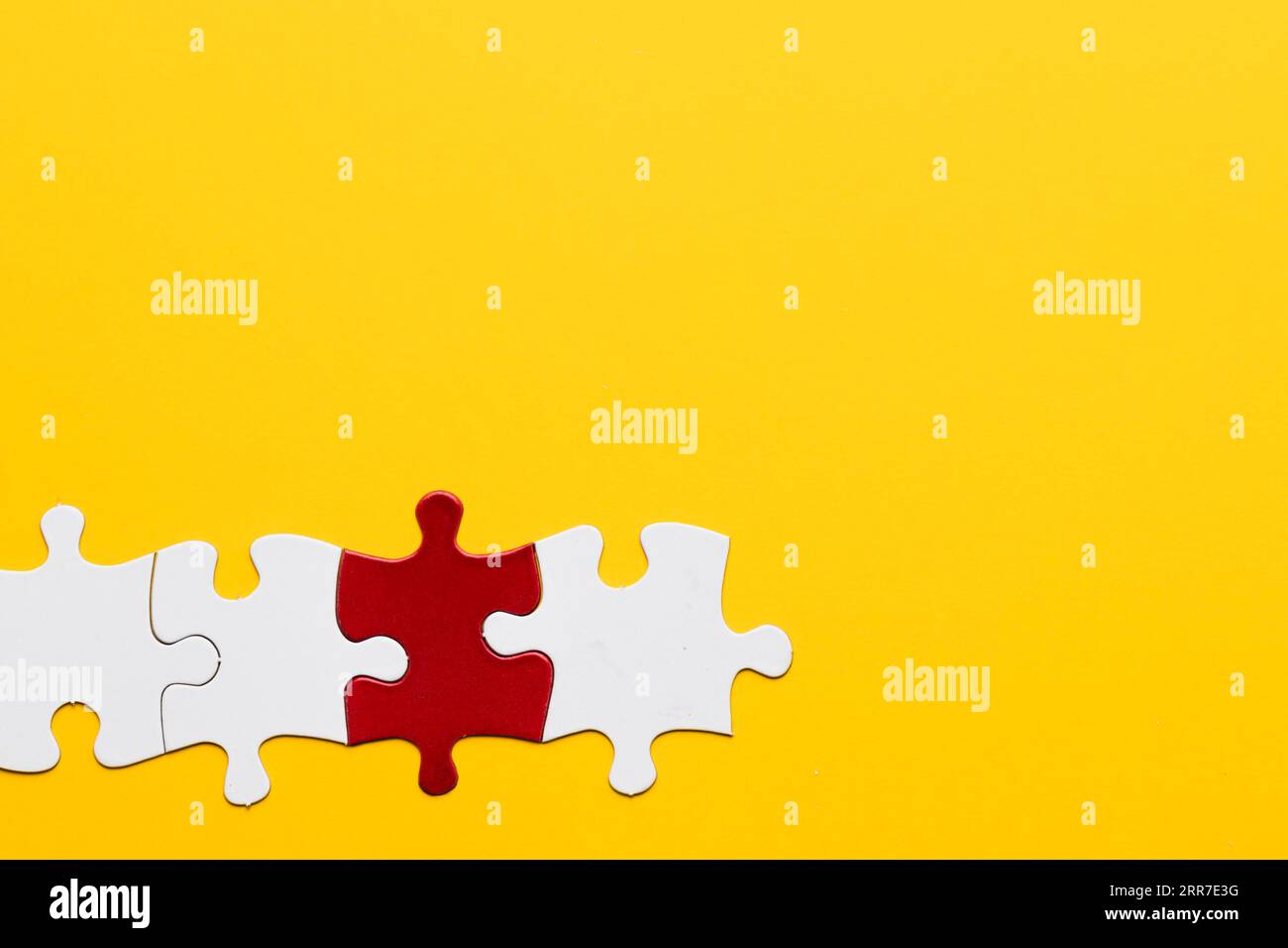 Red white puzzle piece with yellow background Stock Photo - Alamy